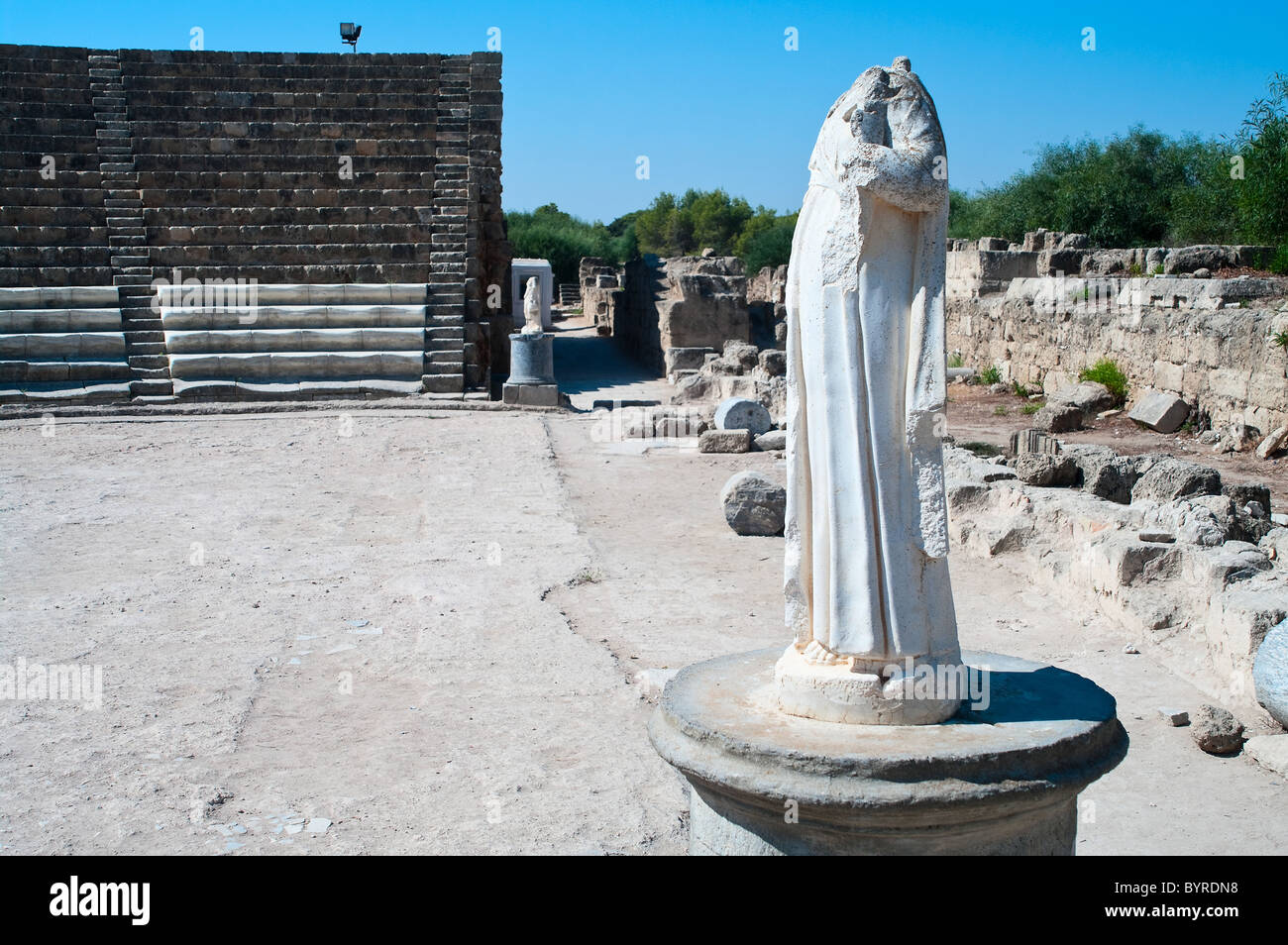 Roman ruins in Salamis ancient city in northern Cyprus. Two statues in ...
