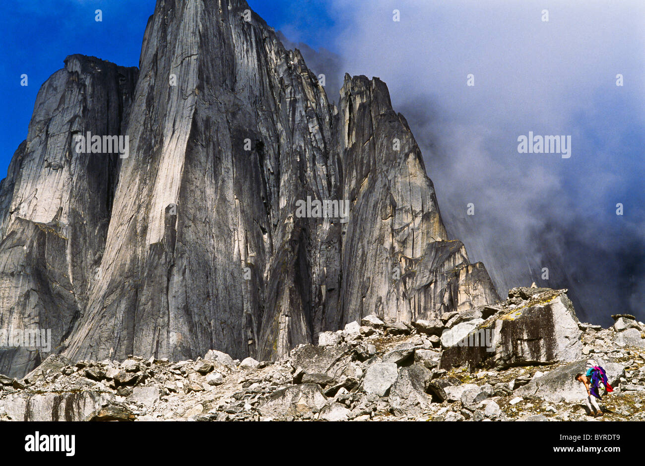 Hiker treks beneath giant rock spires Stock Photo - Alamy