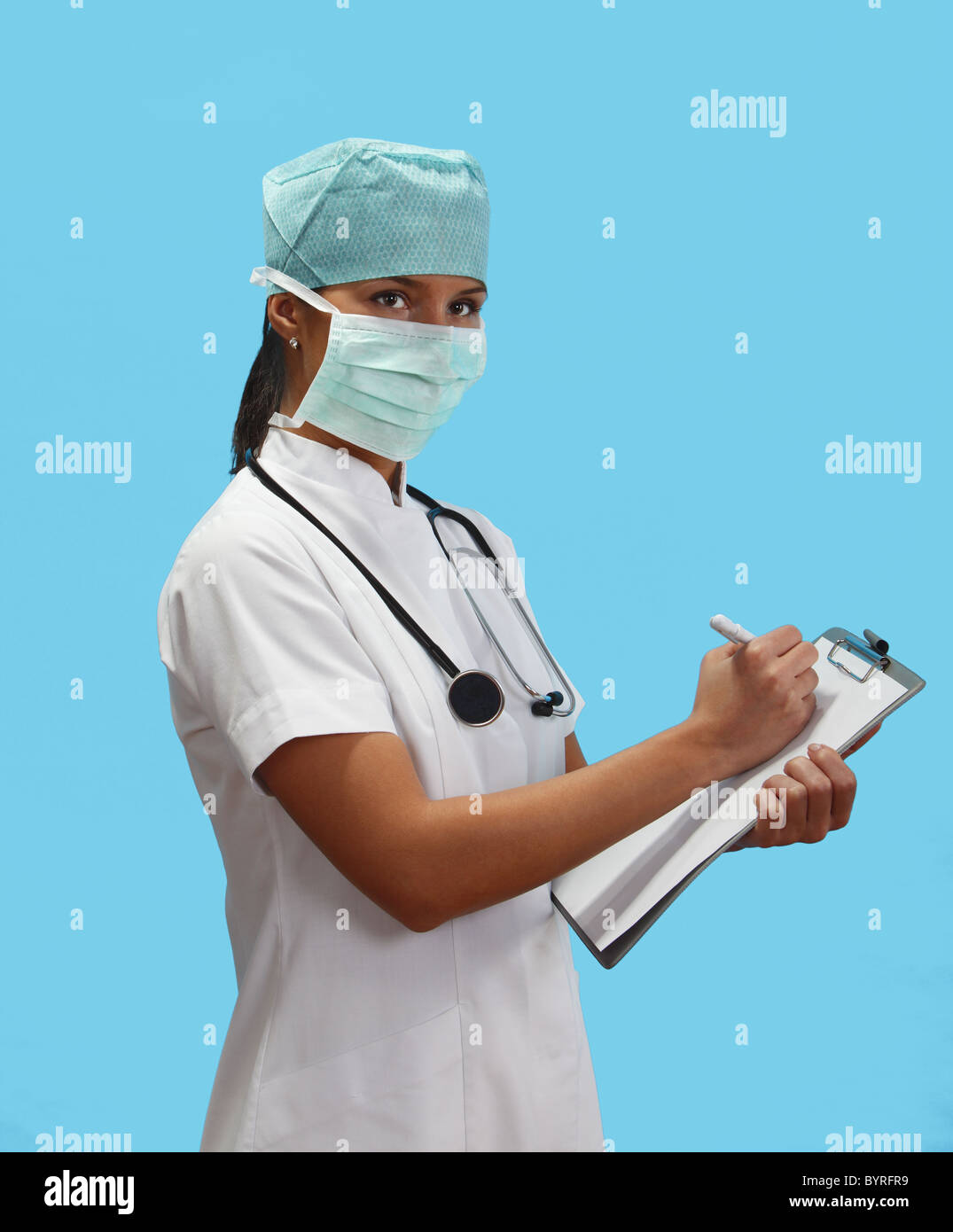 Young woman doctor using a notepad to take down notes, isolated against ...