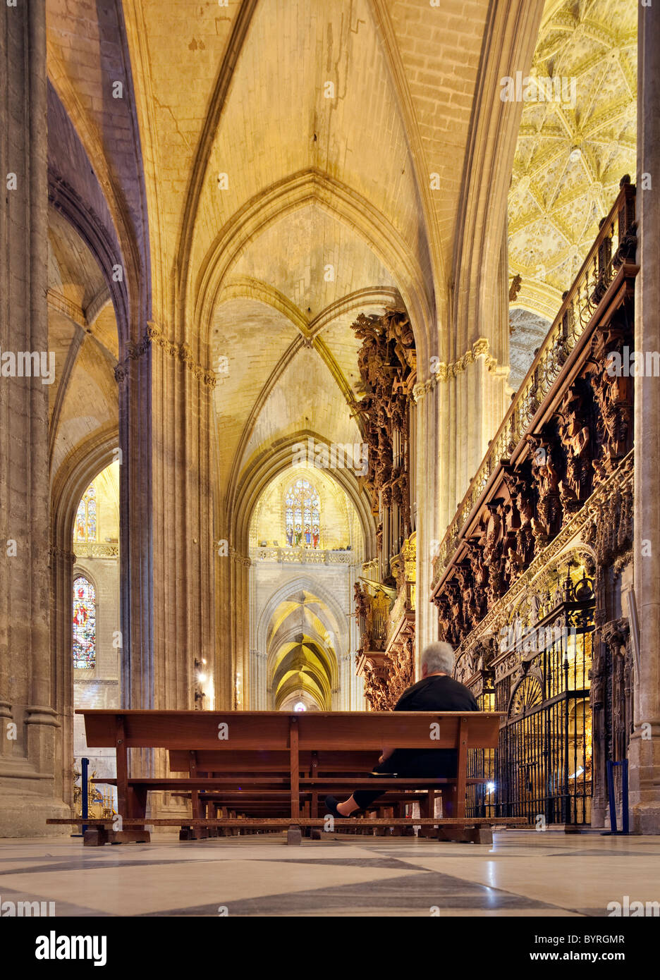Old lady sitting on a bench, Santa Maria de la Sede Cathedral, Seville ...
