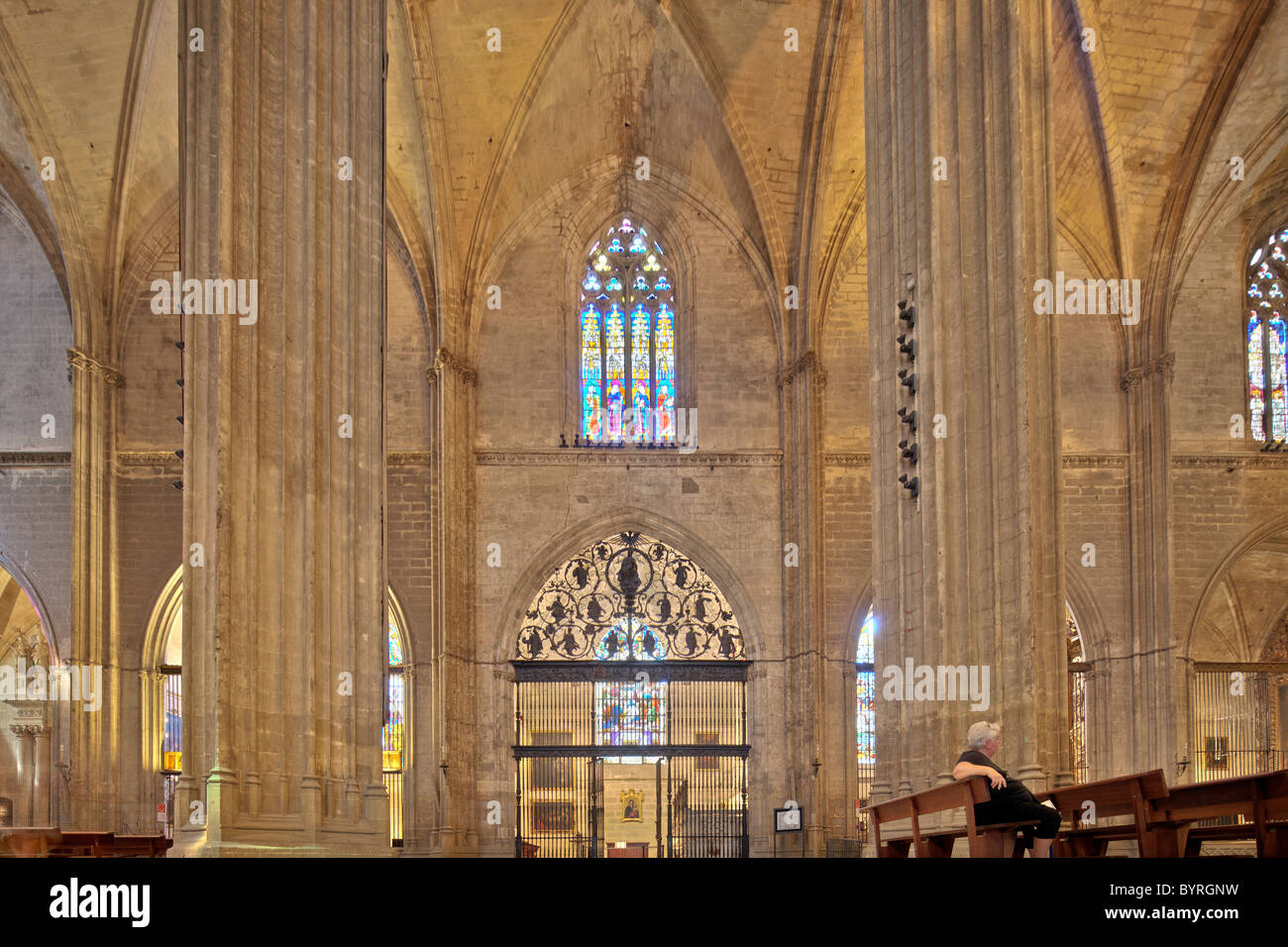 Old lady sitting on a bench, Santa Maria de la Sede Cathedral, Seville ...