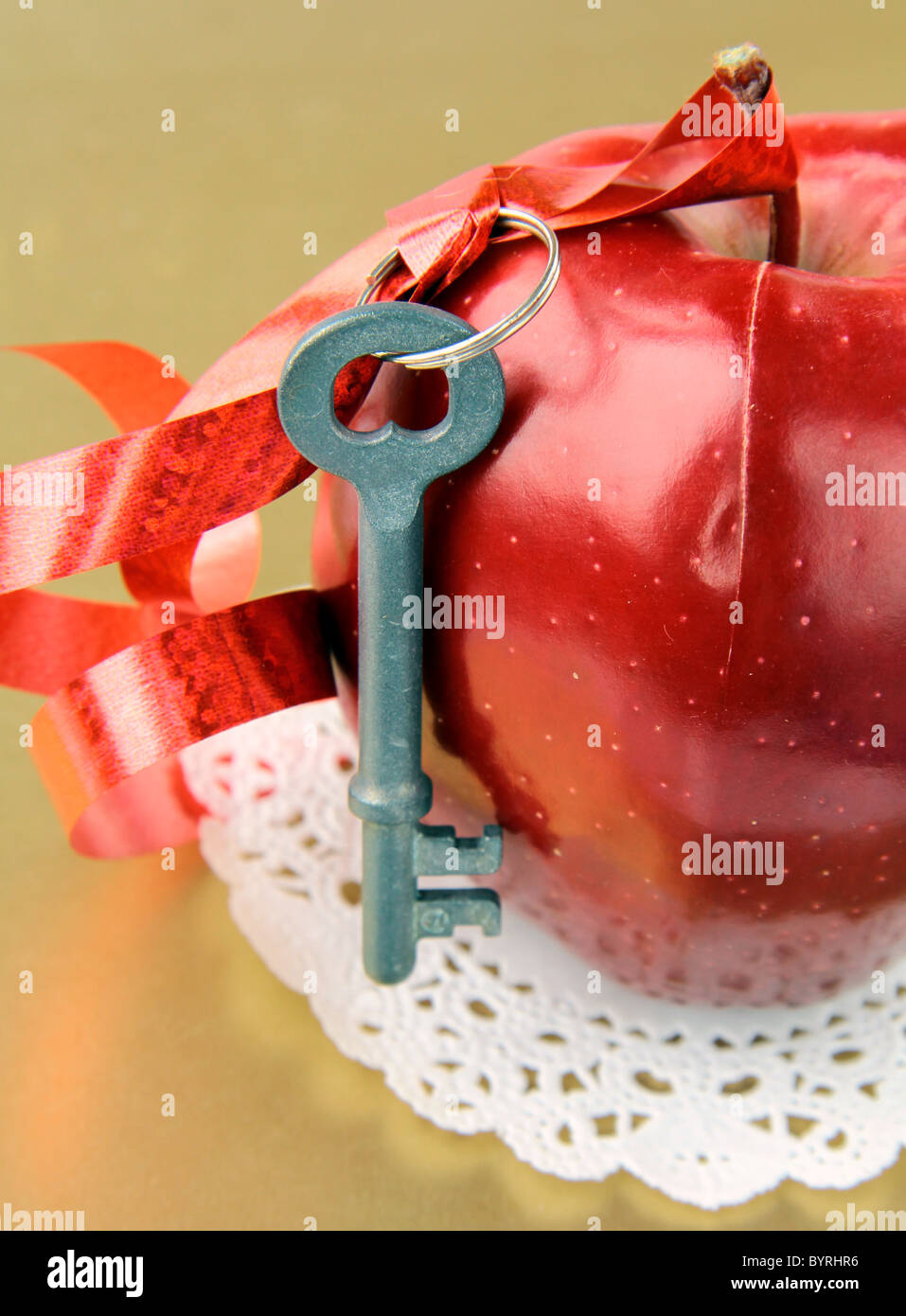red ripe apple with a key and a red ribbon Stock Photo - Alamy