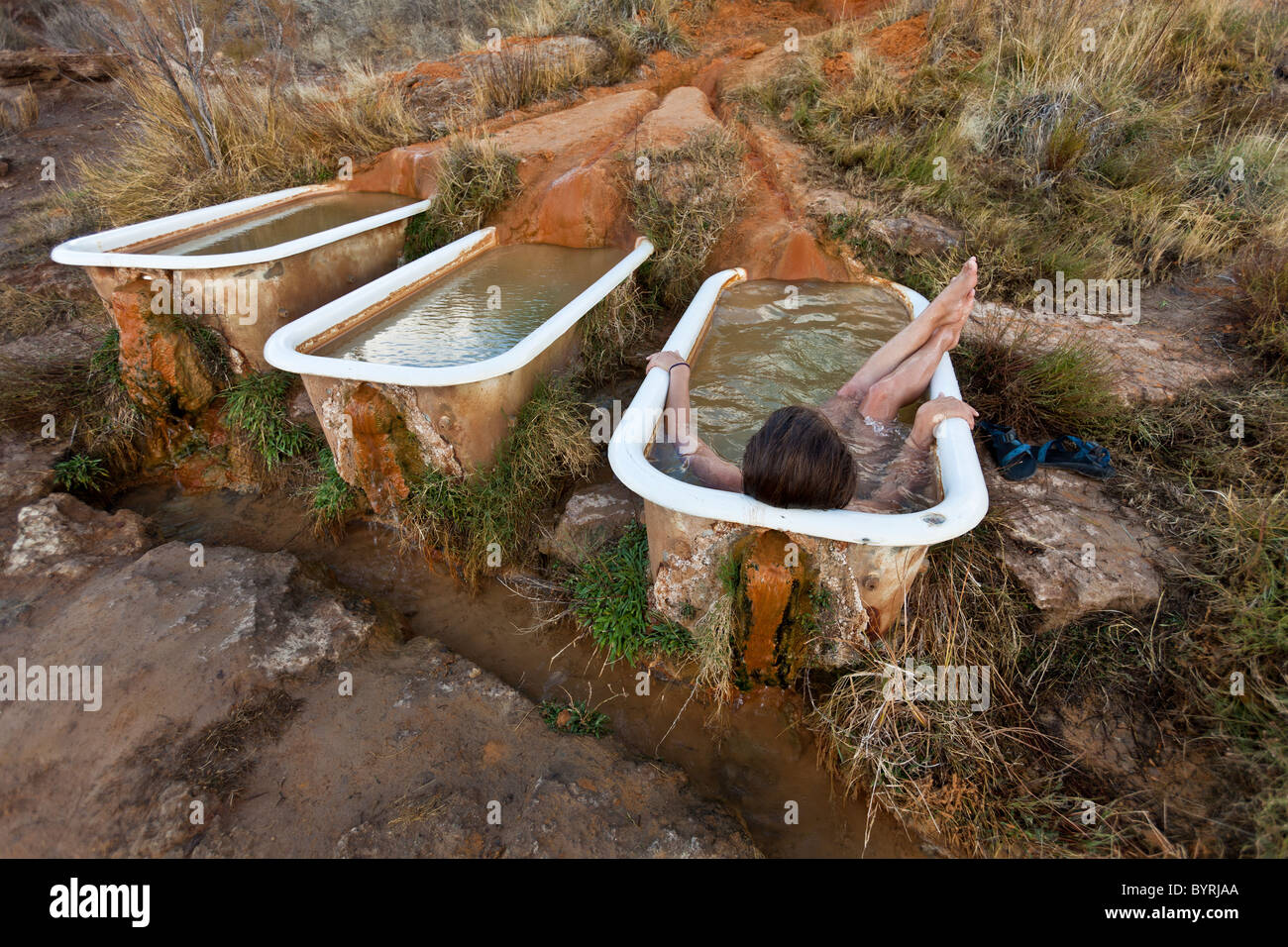 Young woman soaking in the rustic and funky Mystic Hot Springs Stock ...