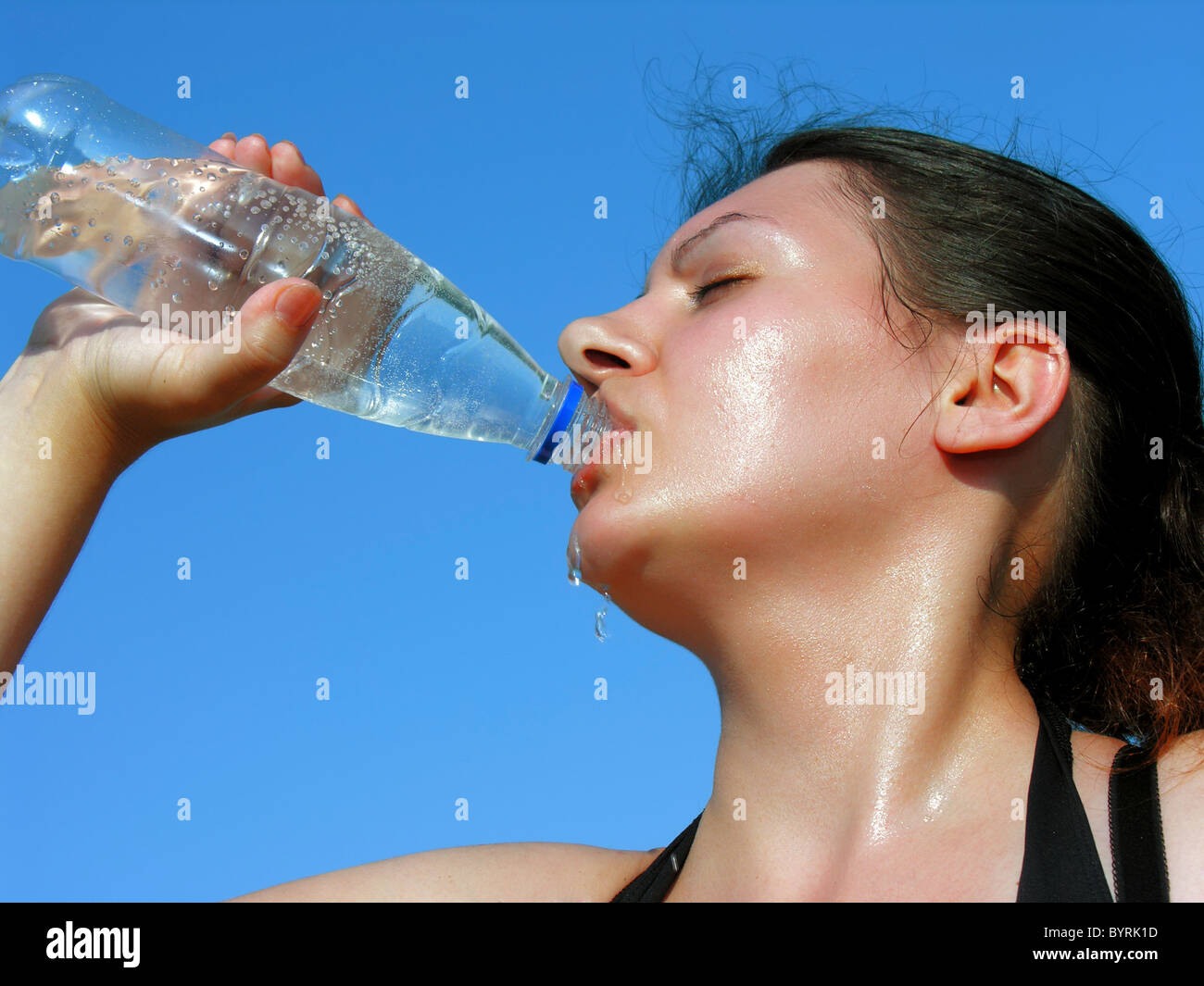 Young woman drinking cold water Stock Photo - Alamy