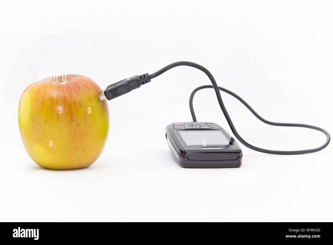 An apple connected to an mobile phone over a wire cable Stock Photo - Alamy
