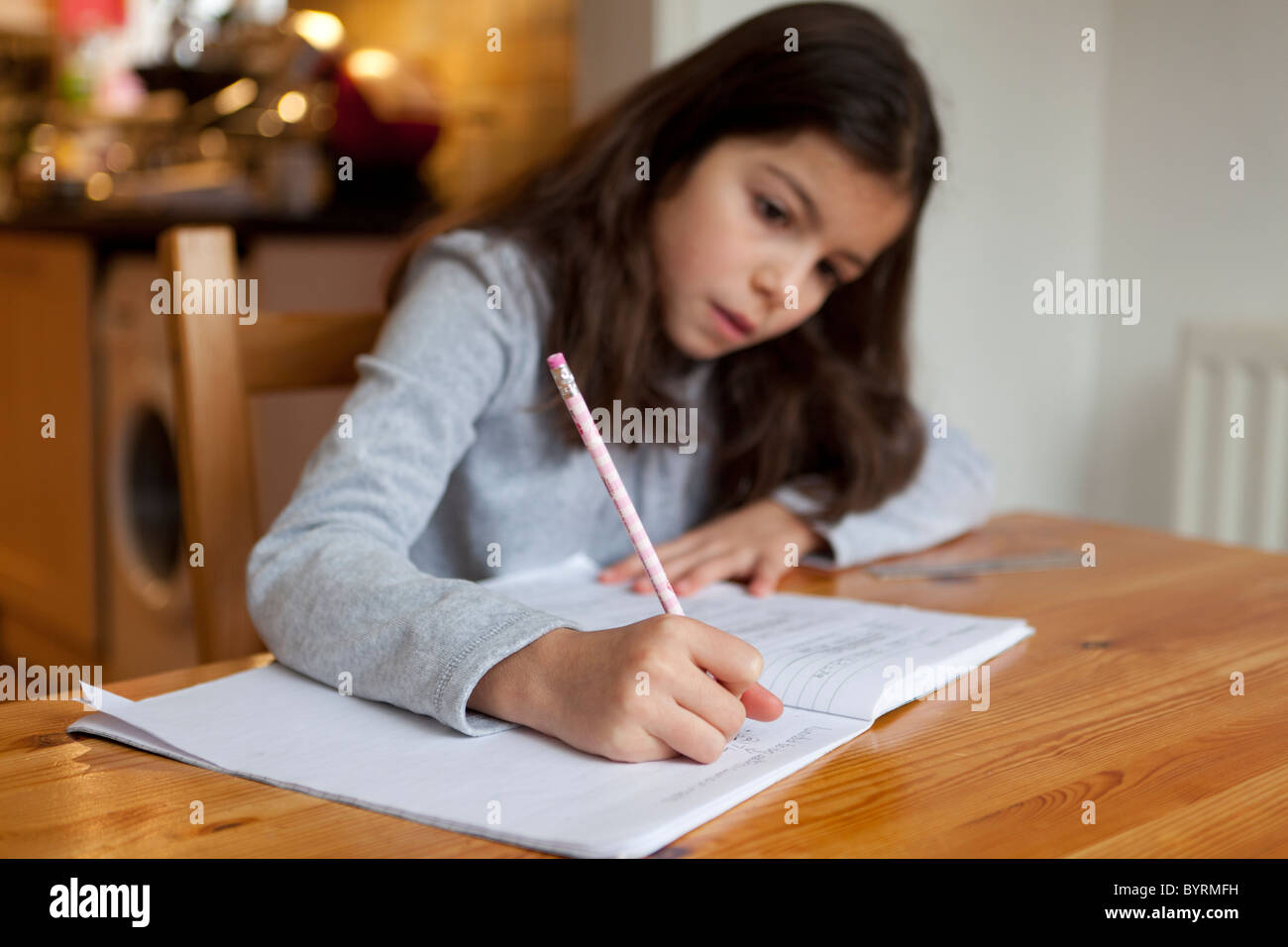 8 year old girl doing her homework Stock Photo - Alamy