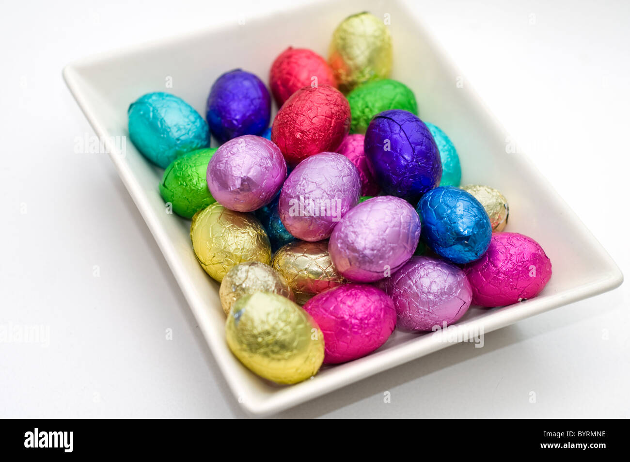 A small selection of mini chocolate eggs in a white dish Stock Photo ...