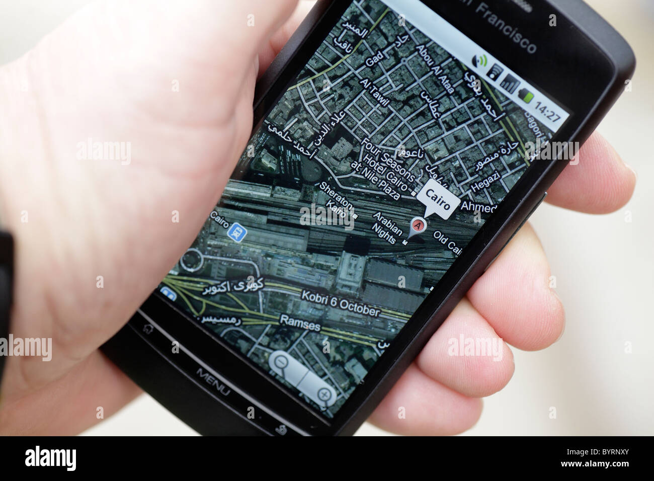 Man looking at google GPS maps map of cairo on a touch screen ...