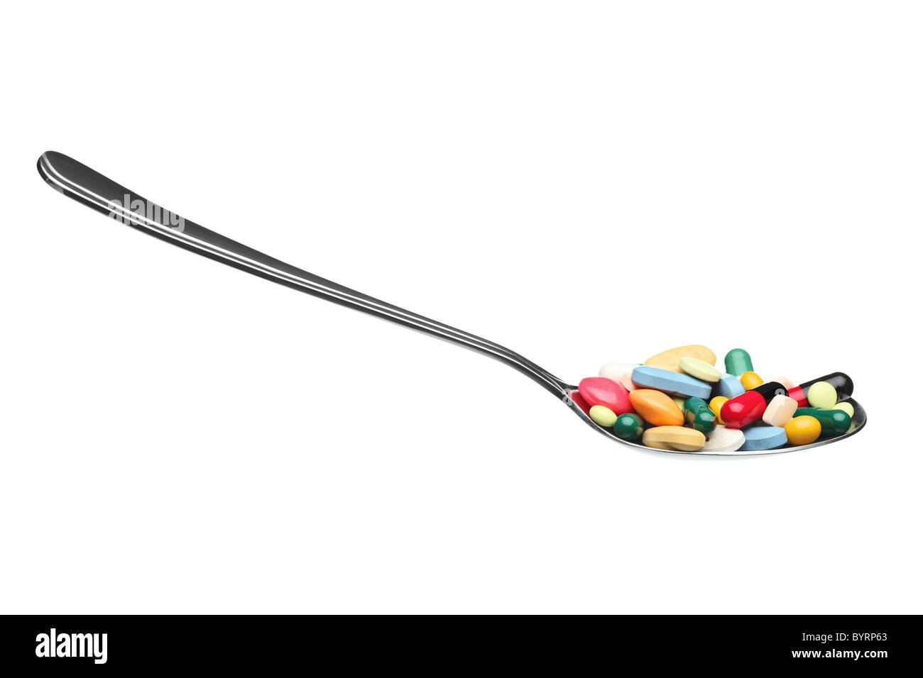 Many tablets and capsules in a spoon Stock Photo - Alamy