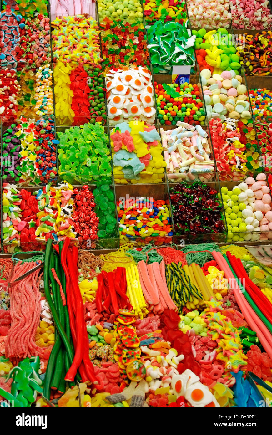 Huge amount of colored sweet things at Barcelona market as background ...