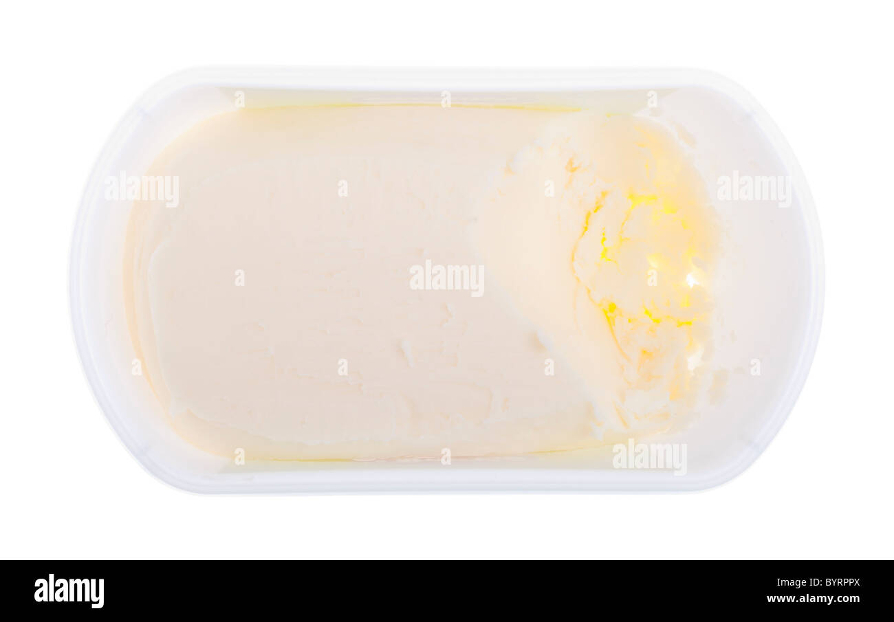 butter close-up on a plastic container isolated on white background ...