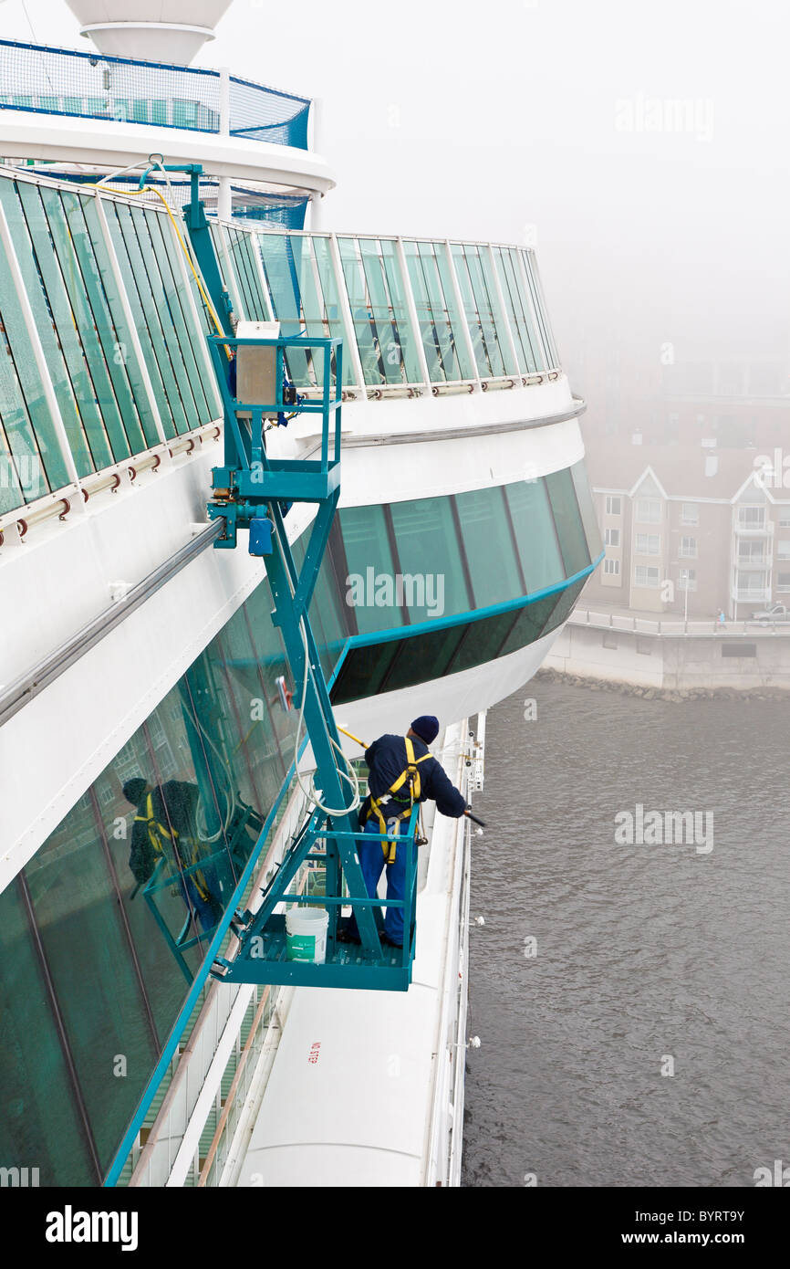 Cruise ship worker washes windows on exterior of the Jewel of the Seas ...