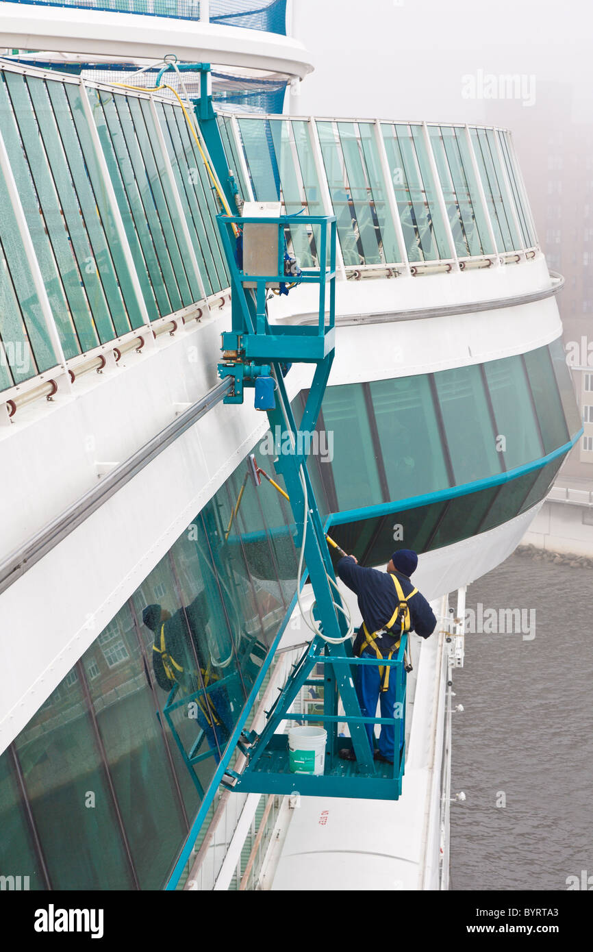 Cruise ship worker washes windows on exterior of the Jewel of the Seas ...