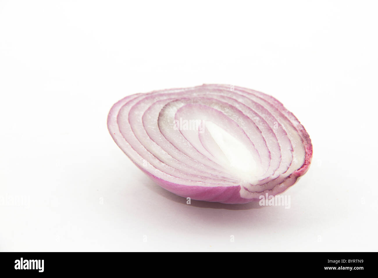 A cross section of a red onion on a white background Stock Photo - Alamy