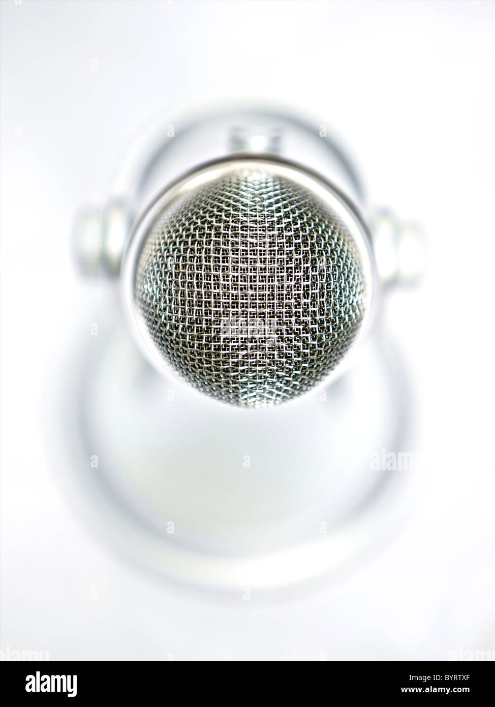An old style microphone photographed in an angle from above against a ...