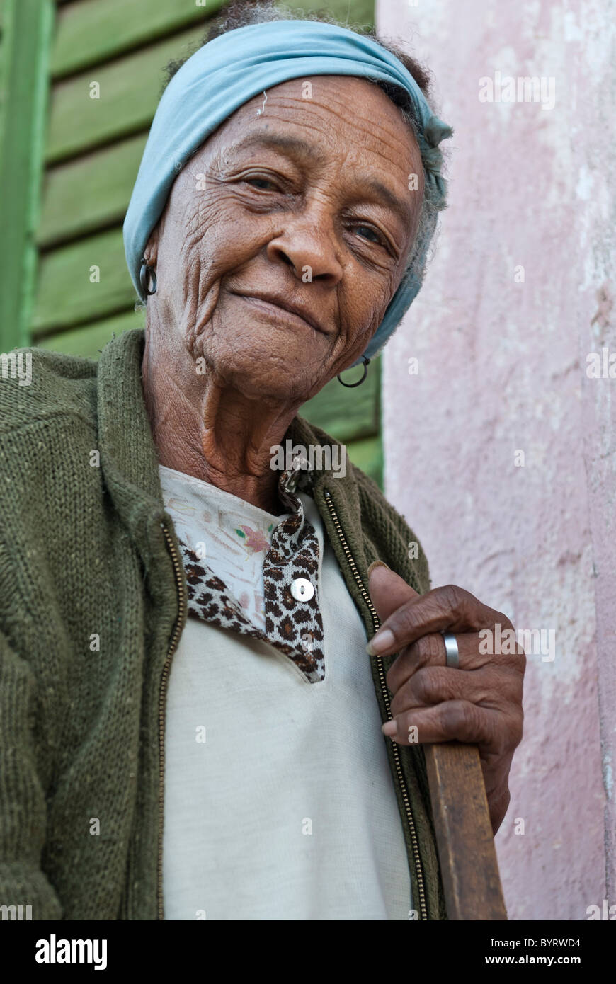 Old woman sweeping the street in front of her house, Trinidad, Sancti ...