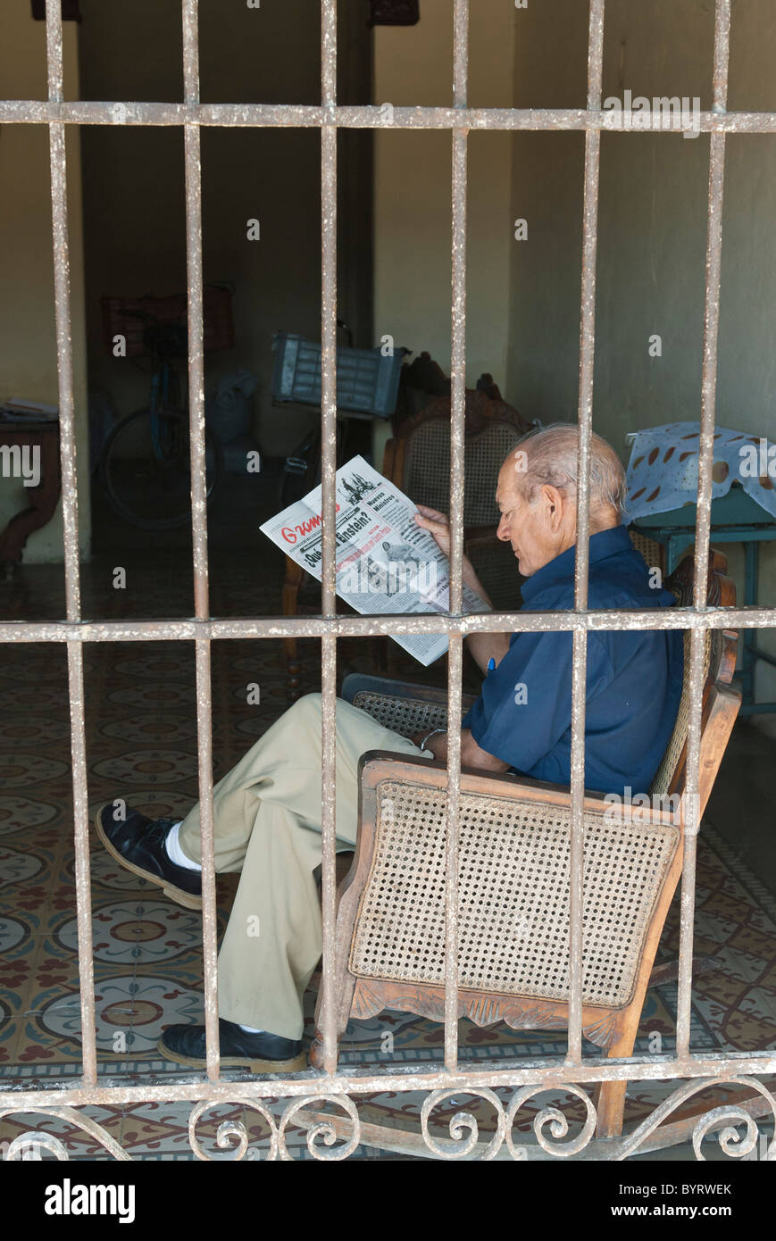 Man sitting by the window reading the newspaper, Palmira, Cienfuegos ...