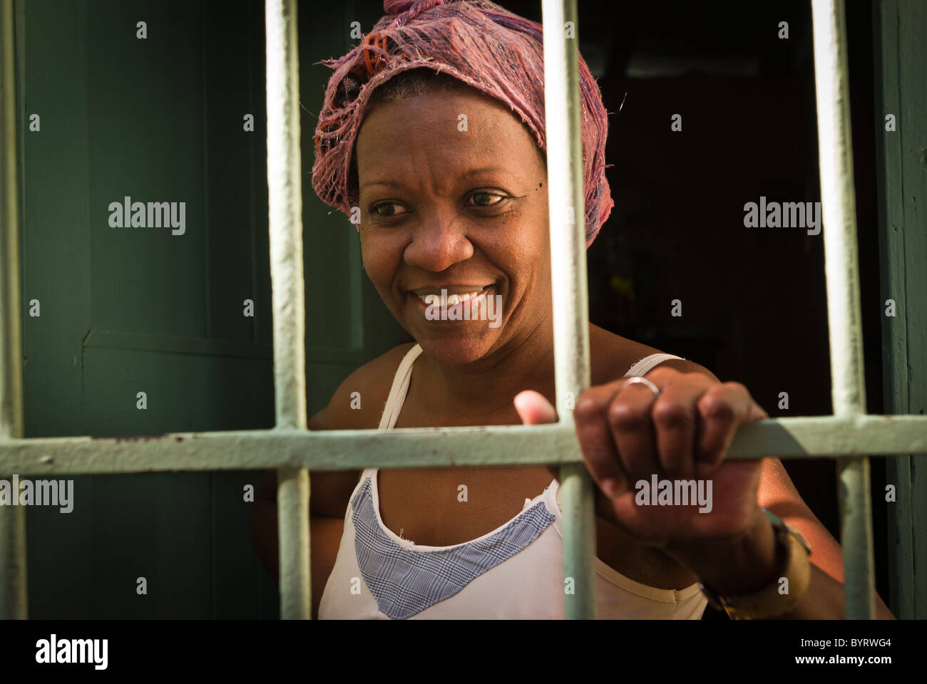 Portrait of a woman behind the bars in her house, La Habana, Cuba Stock ...