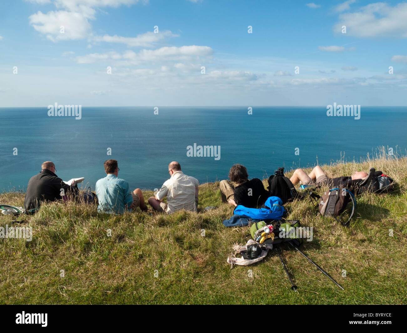 Exhausted walkers rest on cliff overlooking the Bristol Channel ...
