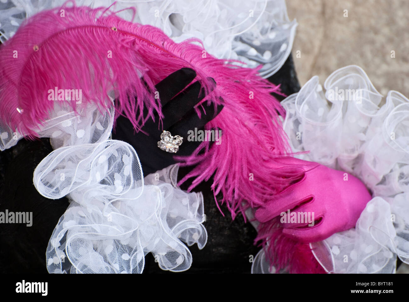 Close-up of hands of a Venetian carnival disguise. One black and one ...