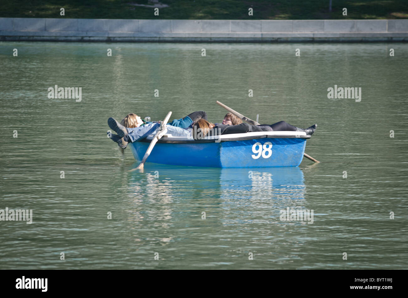People snoozing in rowing boat on boating lake Stock Photo - Alamy
