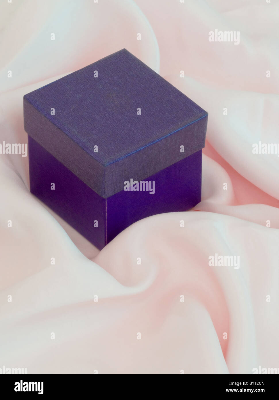 Small square closed purple gift box and lid on pink silk Stock Photo ...