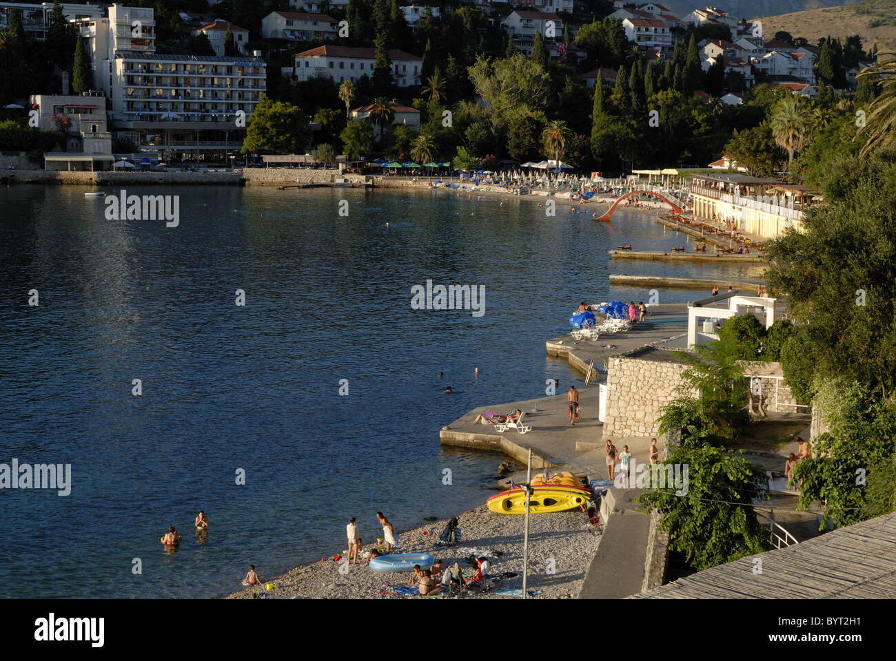 A fine view to the beach of Lapad Bay at the evening light. Locals and ...