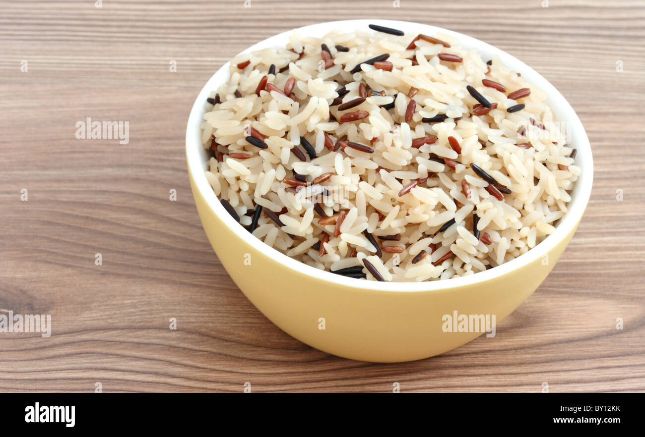 Close up view of cooked variety of rice sorts in yellow bowl - basmati ...