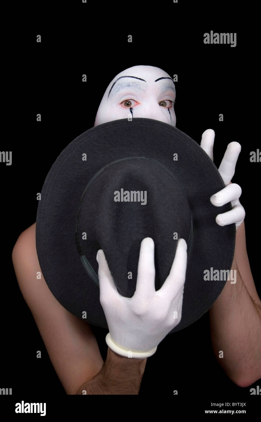 Surprise mime with a hat on a black background Stock Photo - Alamy