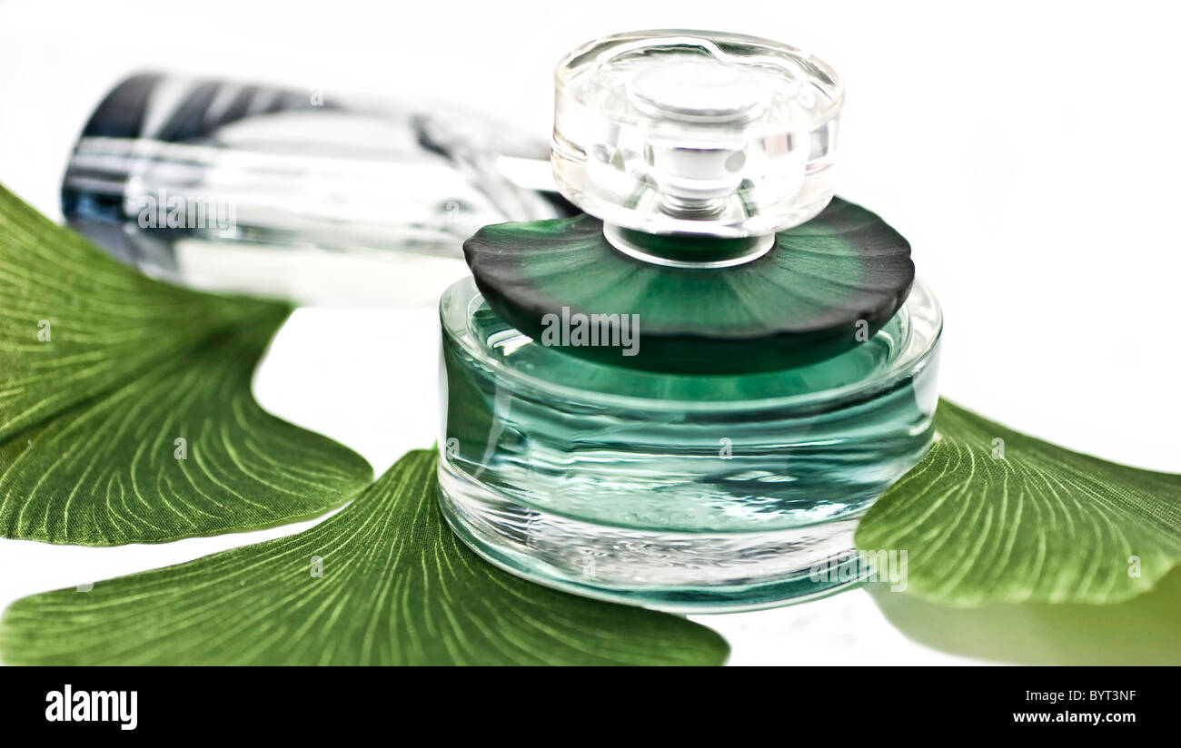 bottles of perfume with the leaves on a white background Stock Photo ...