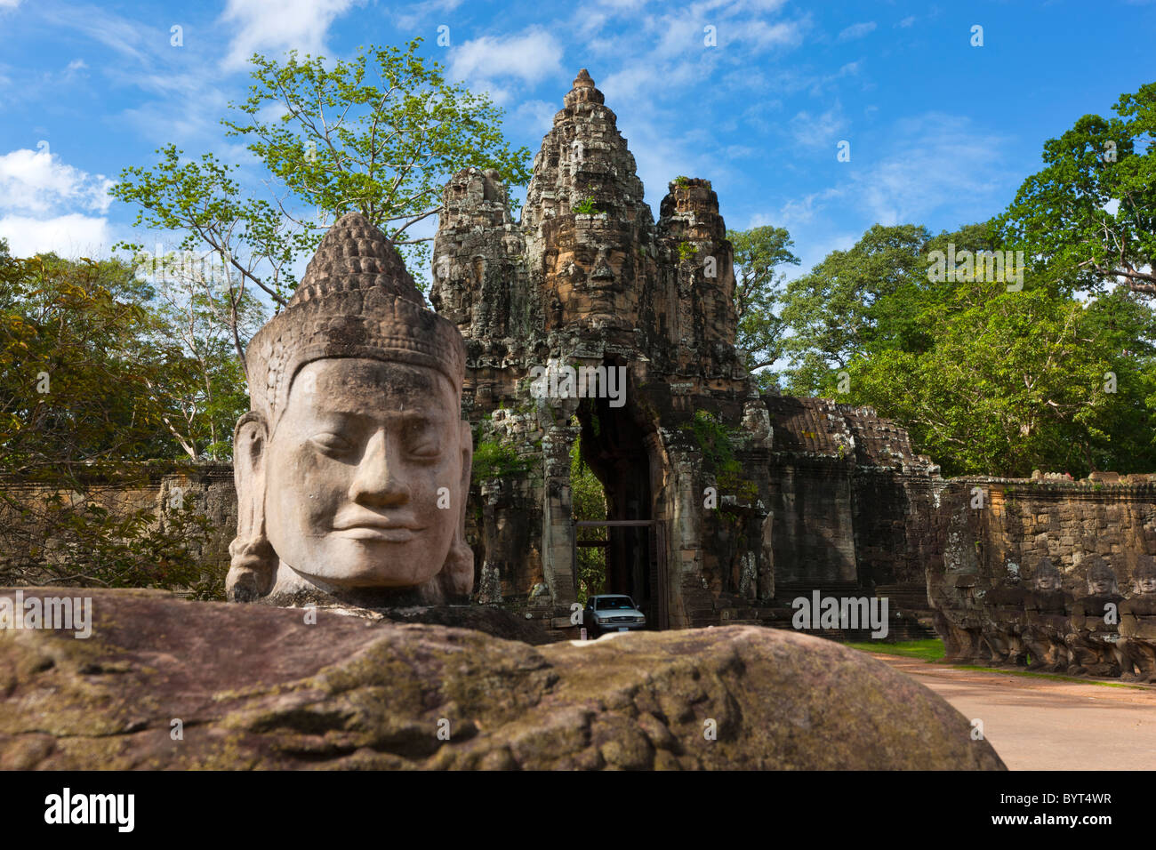 Stone sculptures border the bridge to the temple Angkor Thom in Angkor ...