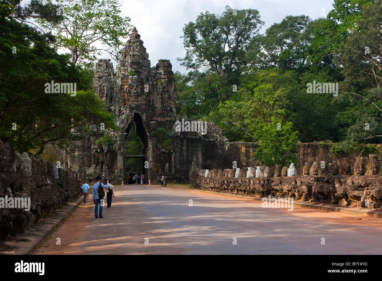 Stone sculptures border the bridge to the temple Angkor Thom in Angkor ...