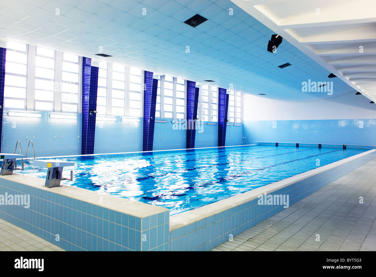 Indoor swimming pool with two starting blocks Stock Photo - Alamy