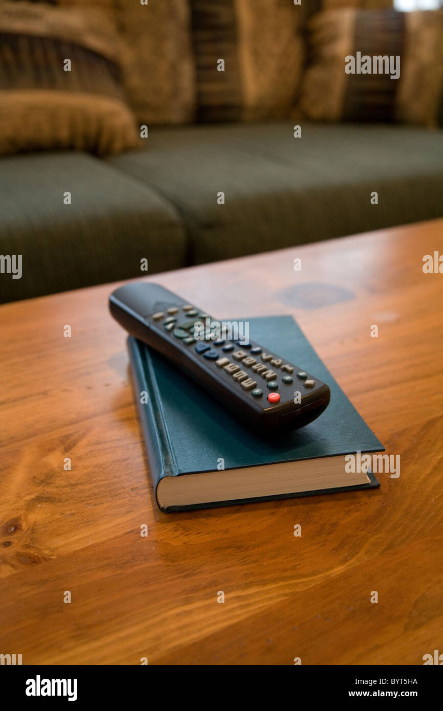 Remote Control, book and coffee table close up shot Stock Photo - Alamy