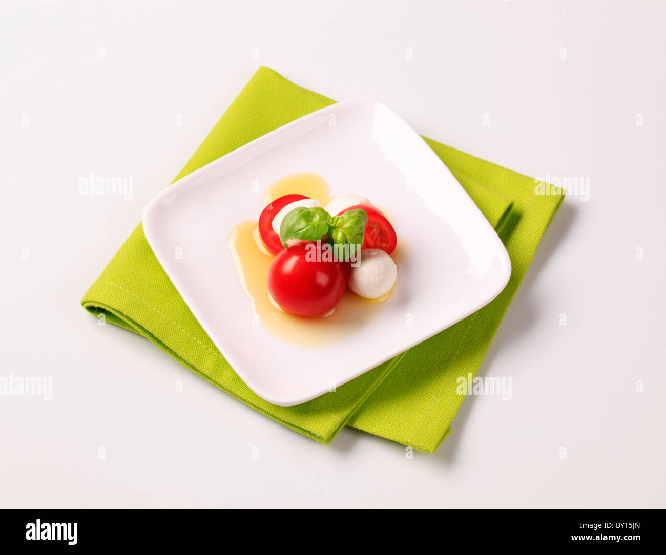 Baby mozzarella cheese balls, tomatoes and basil Stock Photo - Alamy
