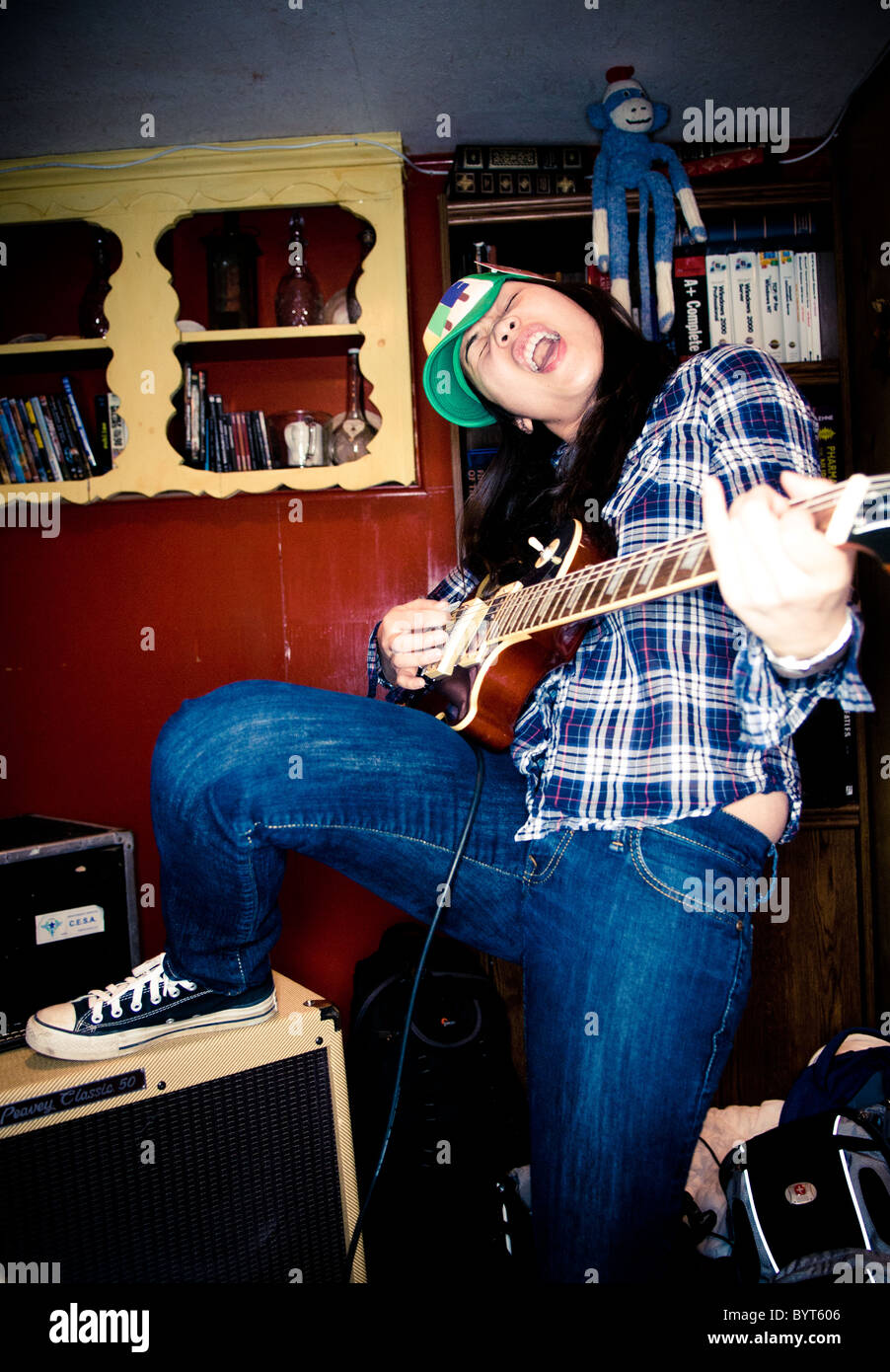 Girl rocking out on a guitar Stock Photo - Alamy