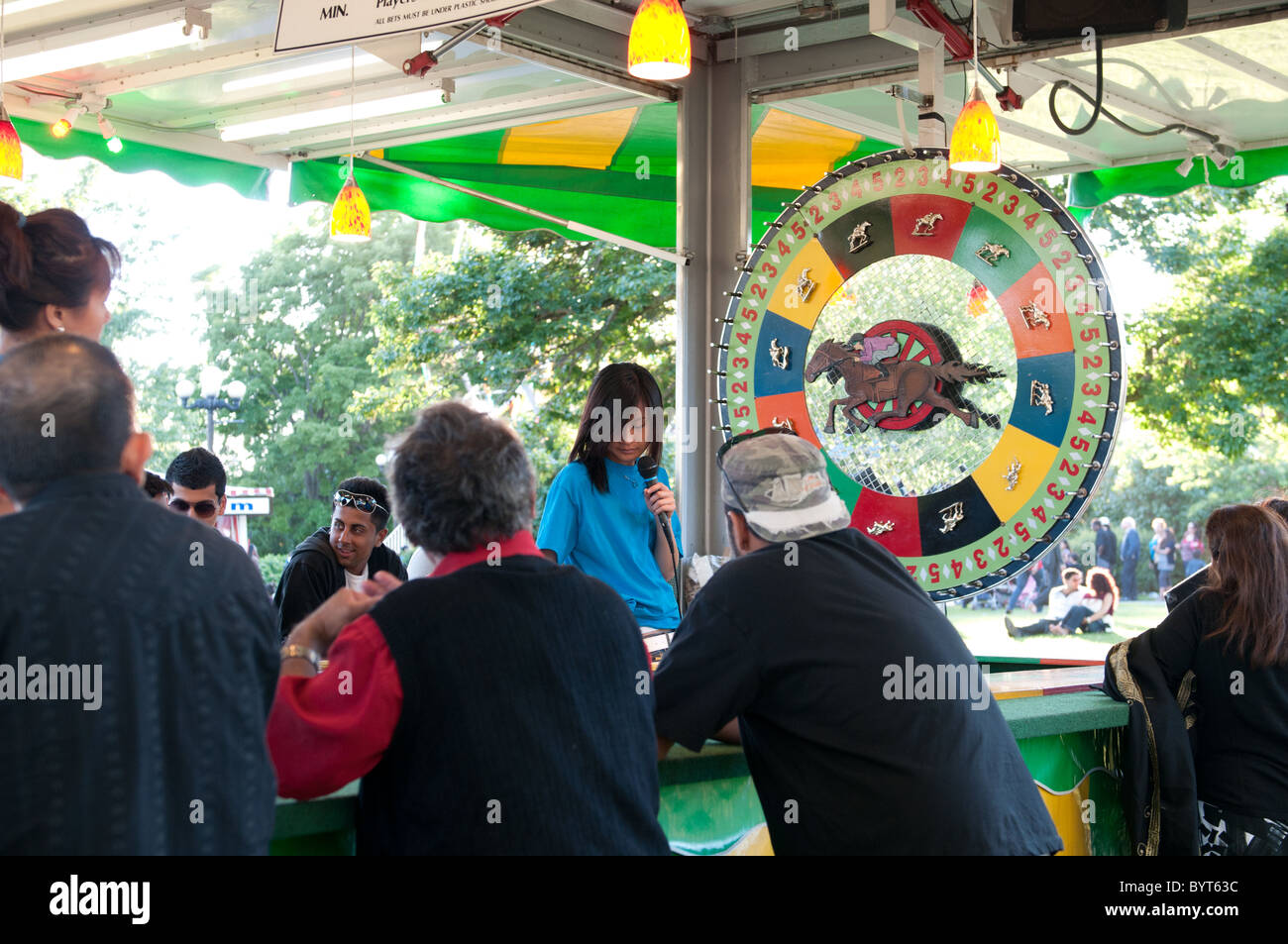 Carnival horse game with people playing Stock Photo - Alamy