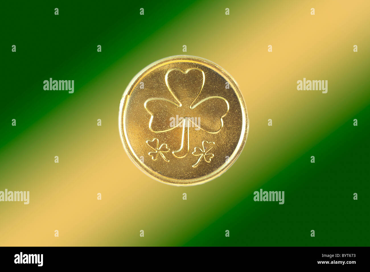 Shamrock gold coin on a colored background Stock Photo - Alamy