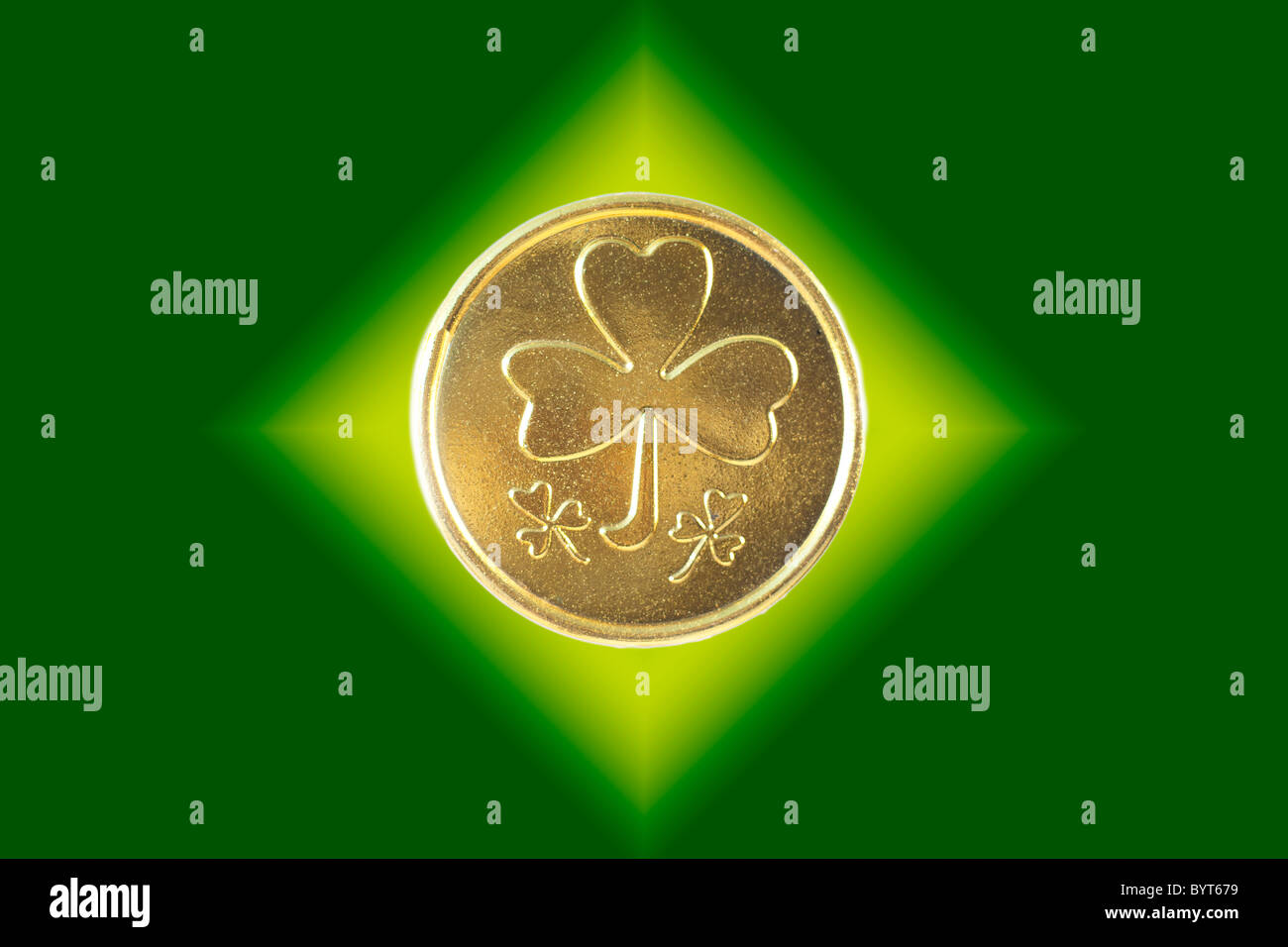 Shamrock gold coin on a colored background Stock Photo - Alamy