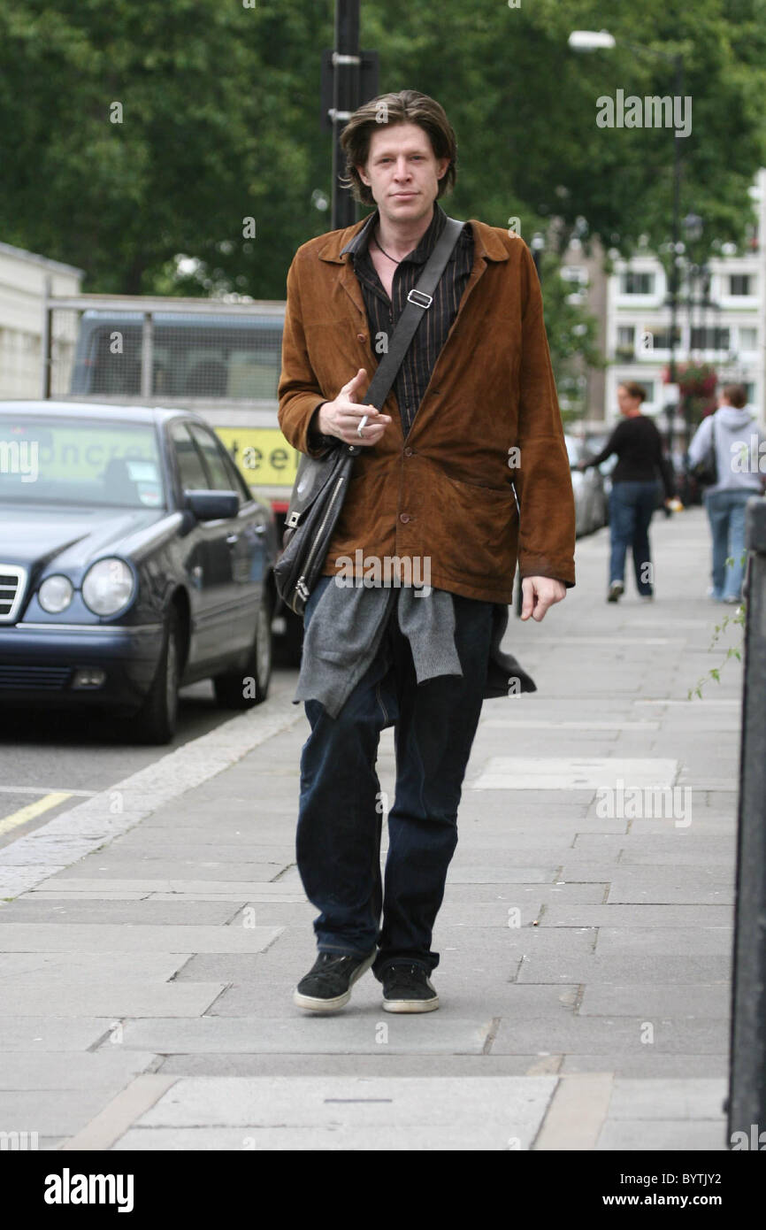 Chris Brosnan takes a cigarette from a photographer, then asks him for ...