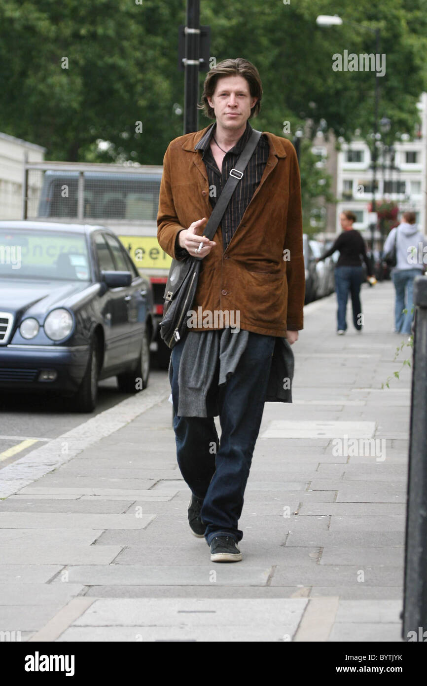 Chris Brosnan takes a cigarette from a photographer, then asks him for ...