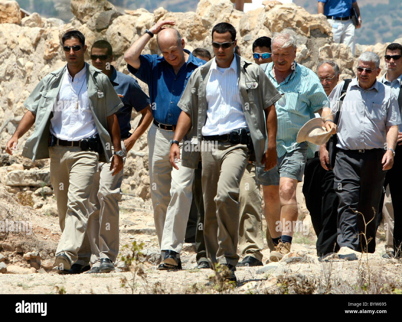 Bodyguards surround Israeli Prime Minister Ehud Olmert during a visit ...