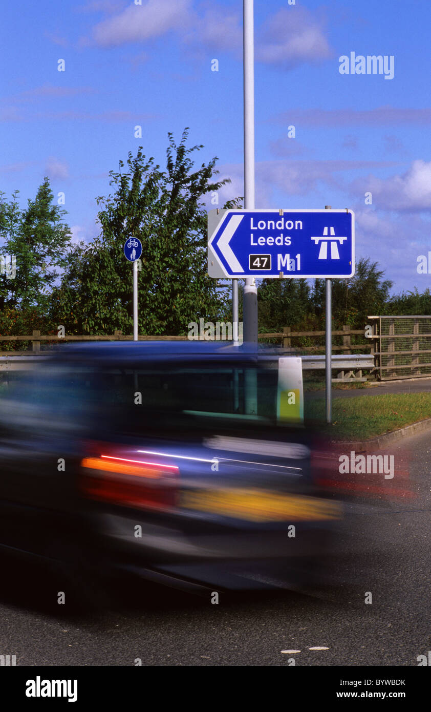 car passing road sign pointing to the M1 motorway Leeds Yorkshire UK ...