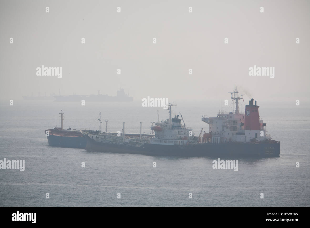 Sea fog off Gibraltar. Ships at anchor Stock Photo - Alamy