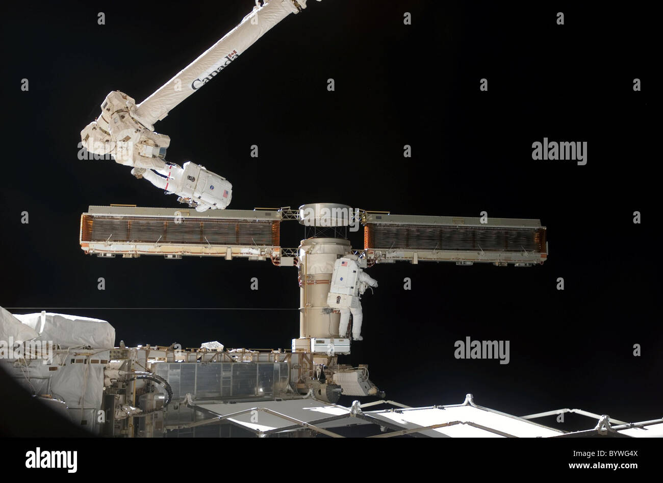 Spacewalk Astronaut Jim Reilly (on robot arm) joins forces with his ...
