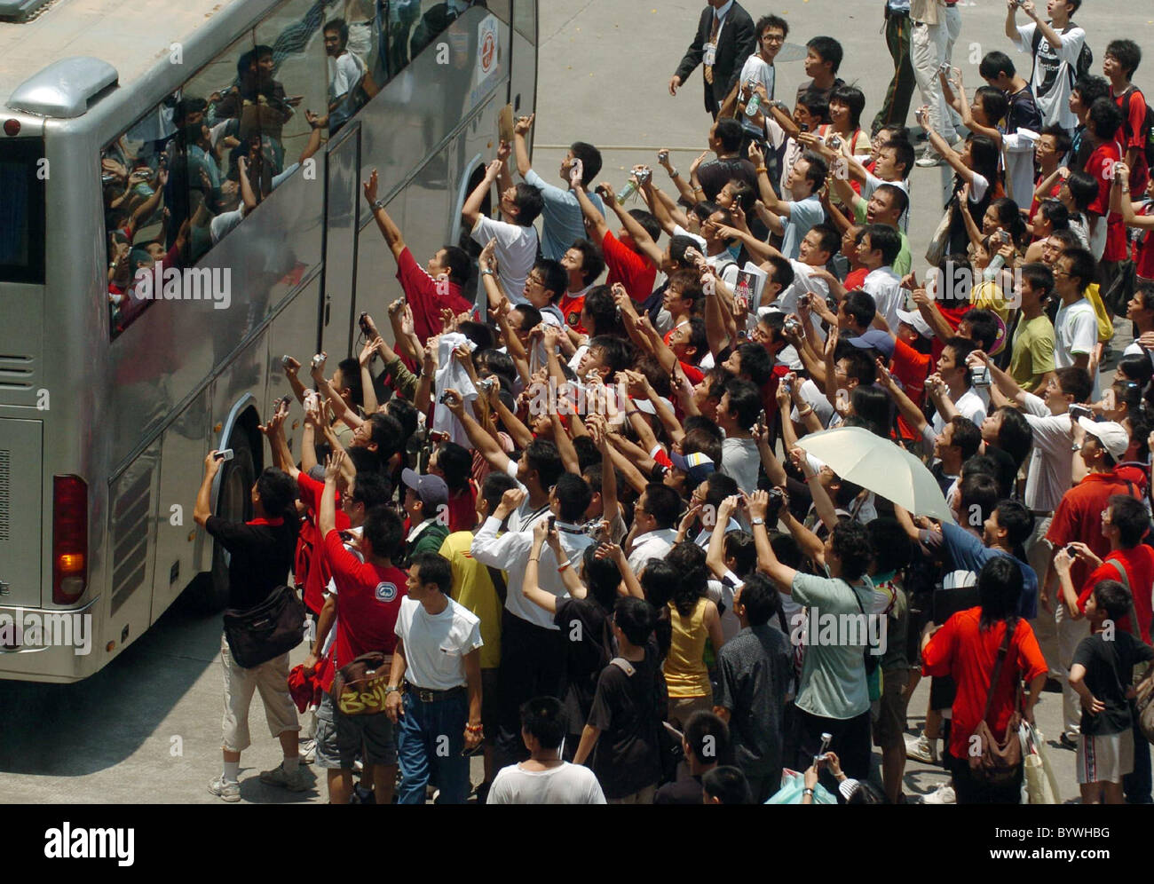 Fans crowd around the coach as Manchester United arrive for their pre ...