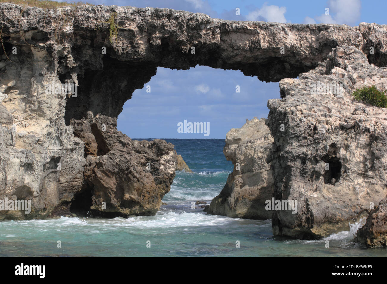 Hell's Gate island, eroded sea arch and shallow sea with waves Stock ...