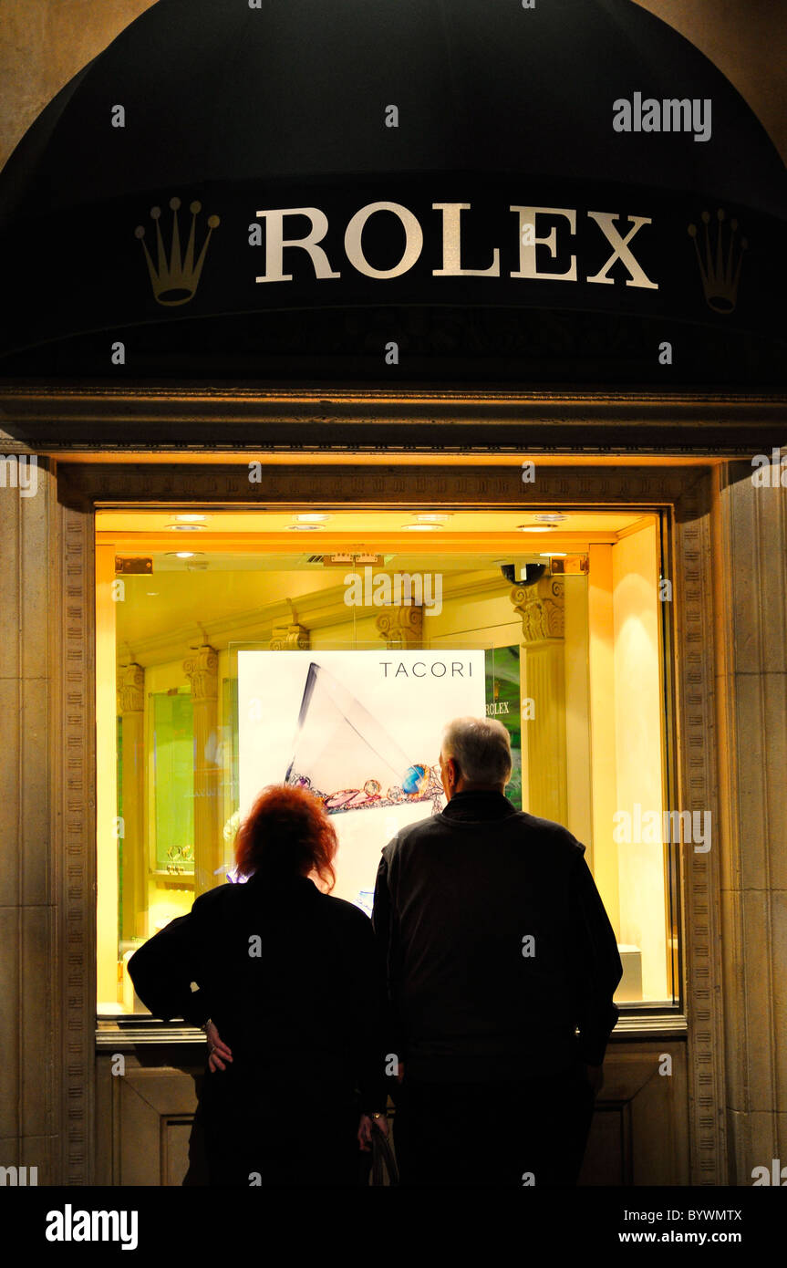 A couple looking into a Rolex store window Stock Photo - Alamy