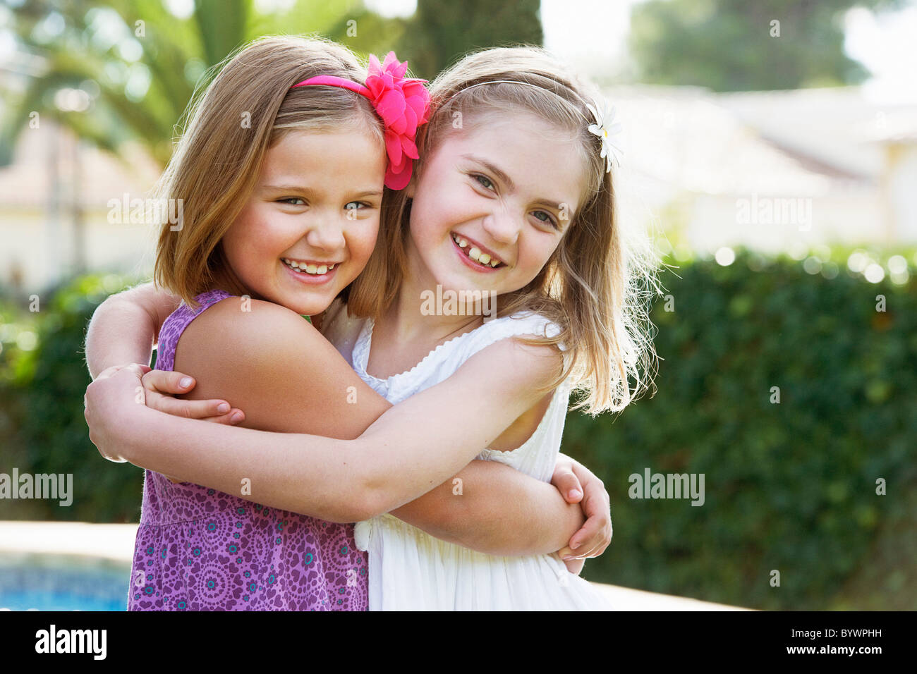 Girls hugging eachother Stock Photo - Alamy