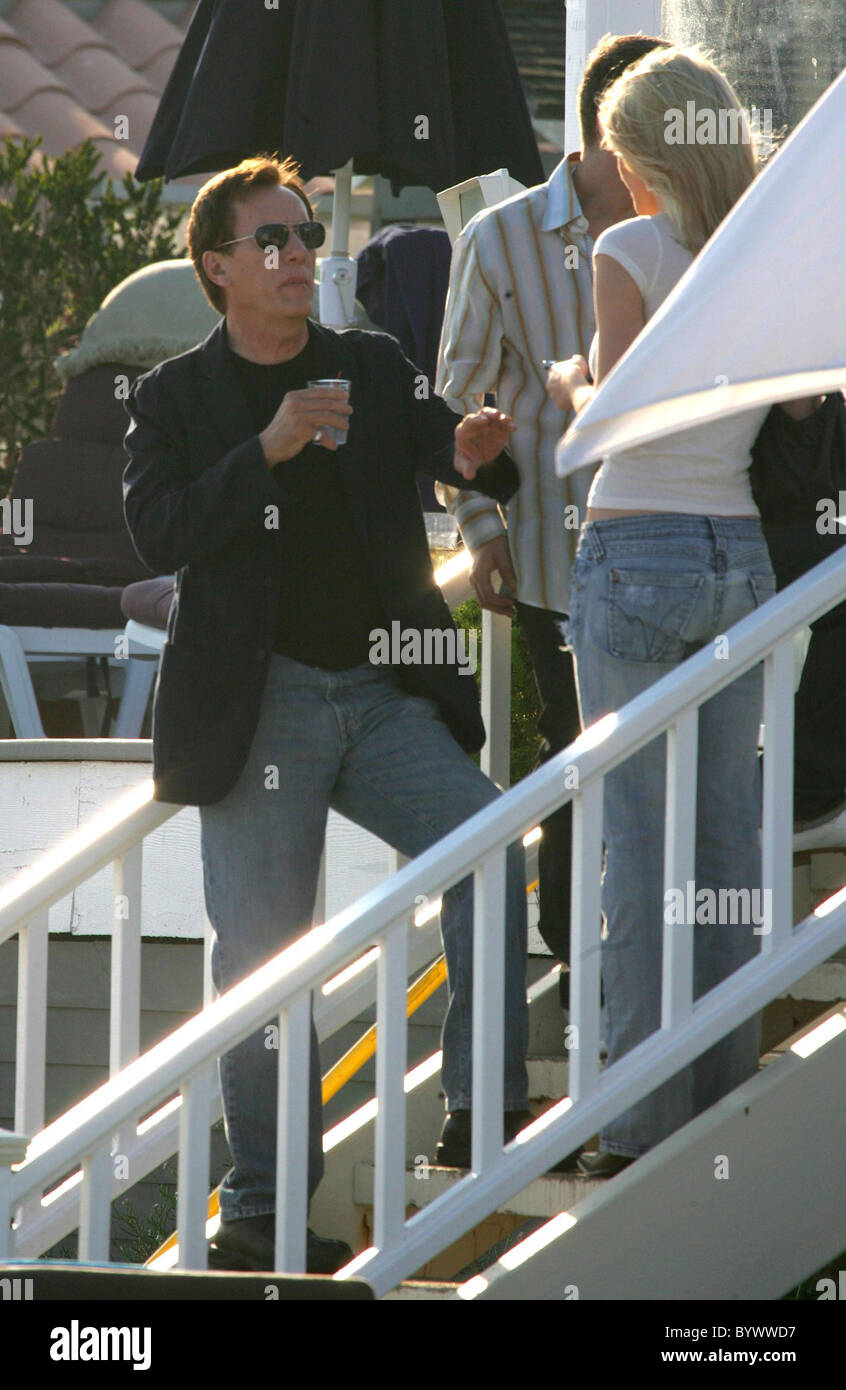 James Woods hangs out with friends at a beach party. Woods is currently ...